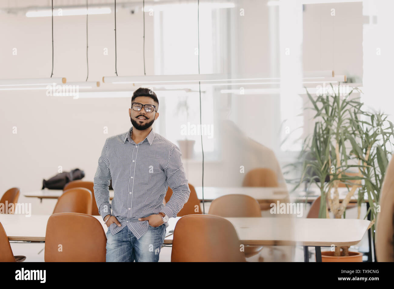 happy indian business man standing in office Stock Photo - Alamy
