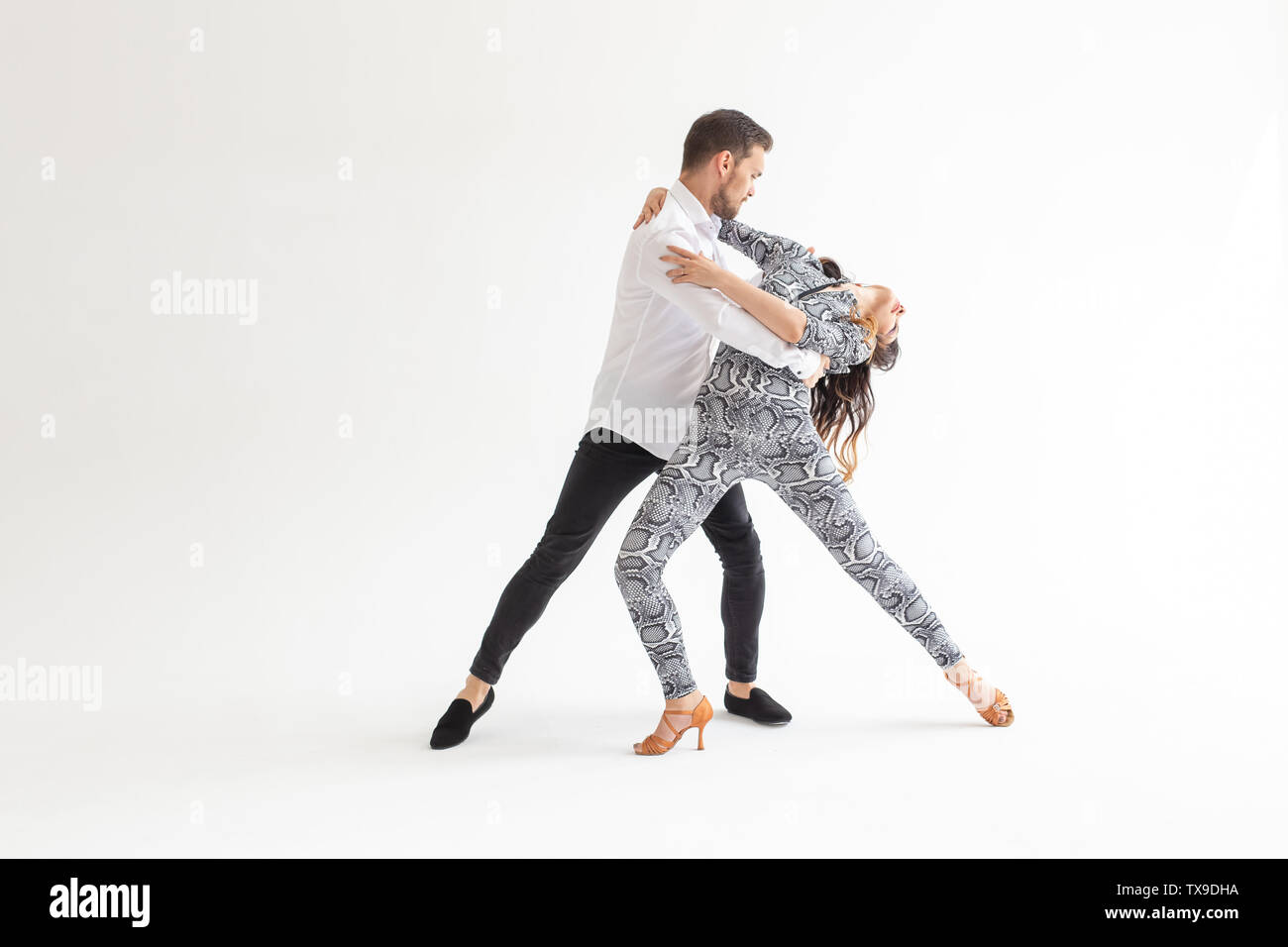 Social dance concept - Active happy adults dancing bachata together ...