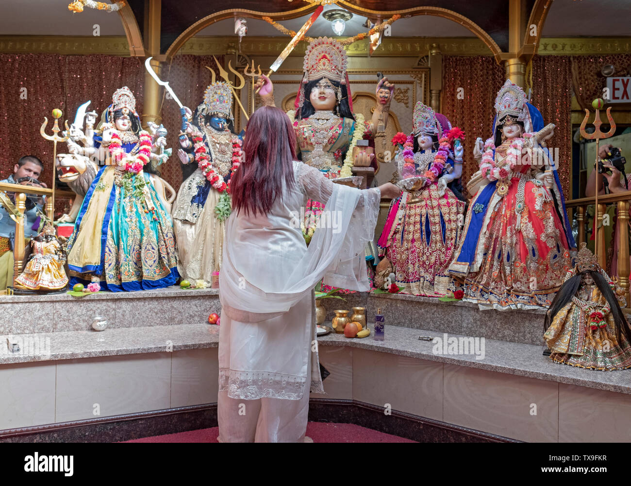 A Hindu women performs the ritual of aarti offering light & flames to ...
