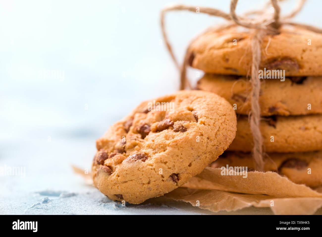 Drop cookies tied in stack on craft baking paper isolated on pastel ...