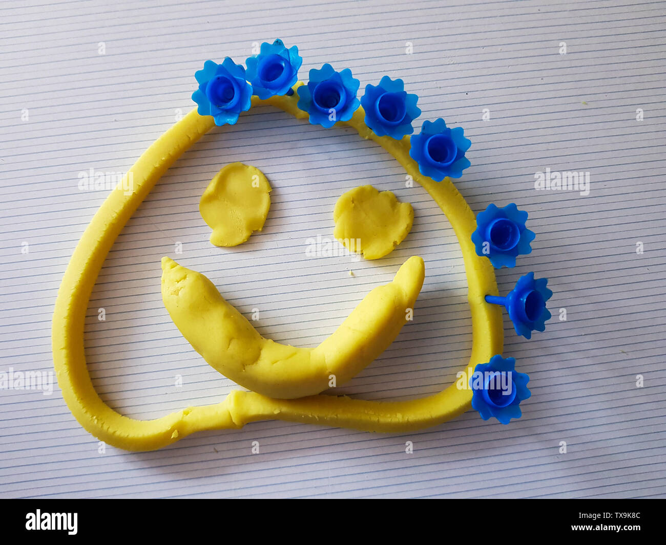 Fanny face made of a modeling clay. Mede by child Stock Photo - Alamy