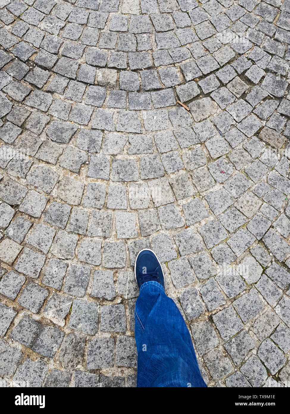 Picture taken up to down of foot on a paved floor Stock Photo - Alamy