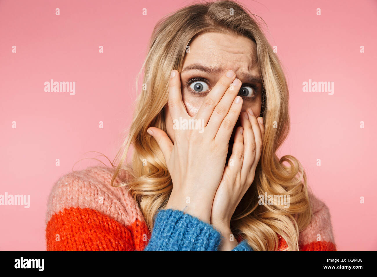Image of a scared nervous young pretty beautiful woman posing isolated ...