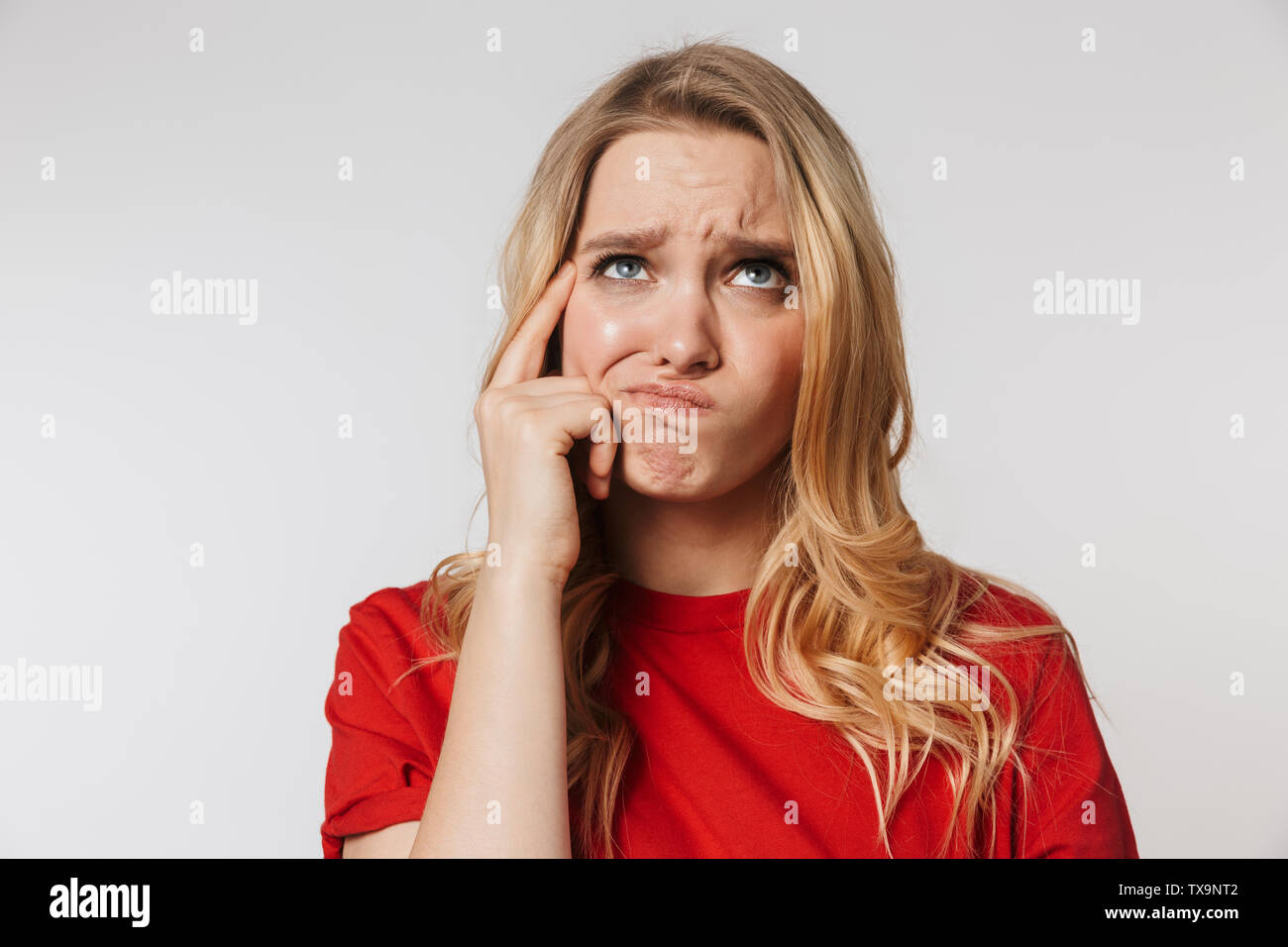 Image of thinking confused young pretty beautiful woman posing isolated ...