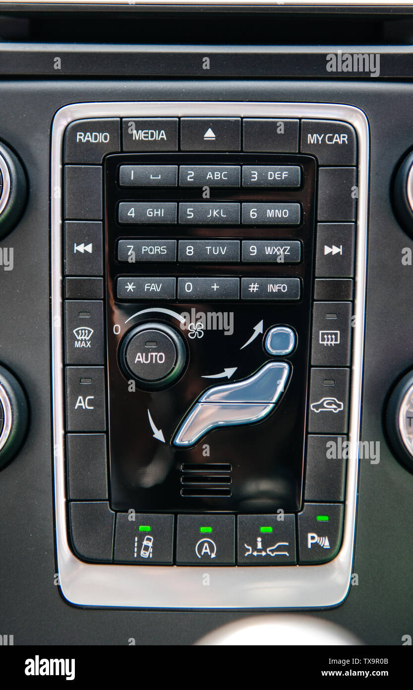 Front view of modern luxury car dashboard with control of the phone ...