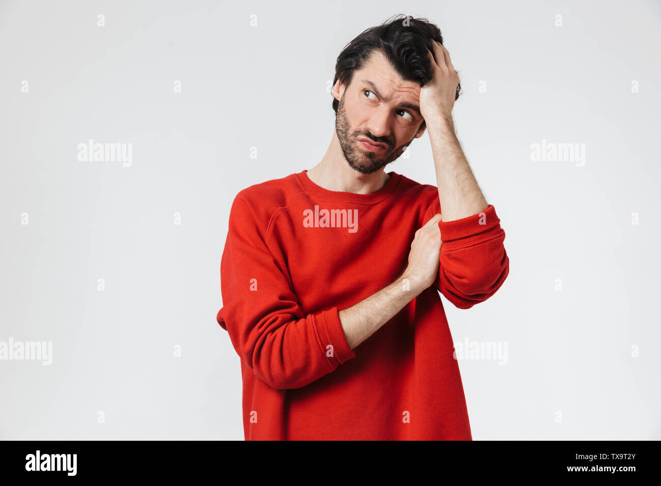 Picture of a handsome young confused man posing isolated over white ...