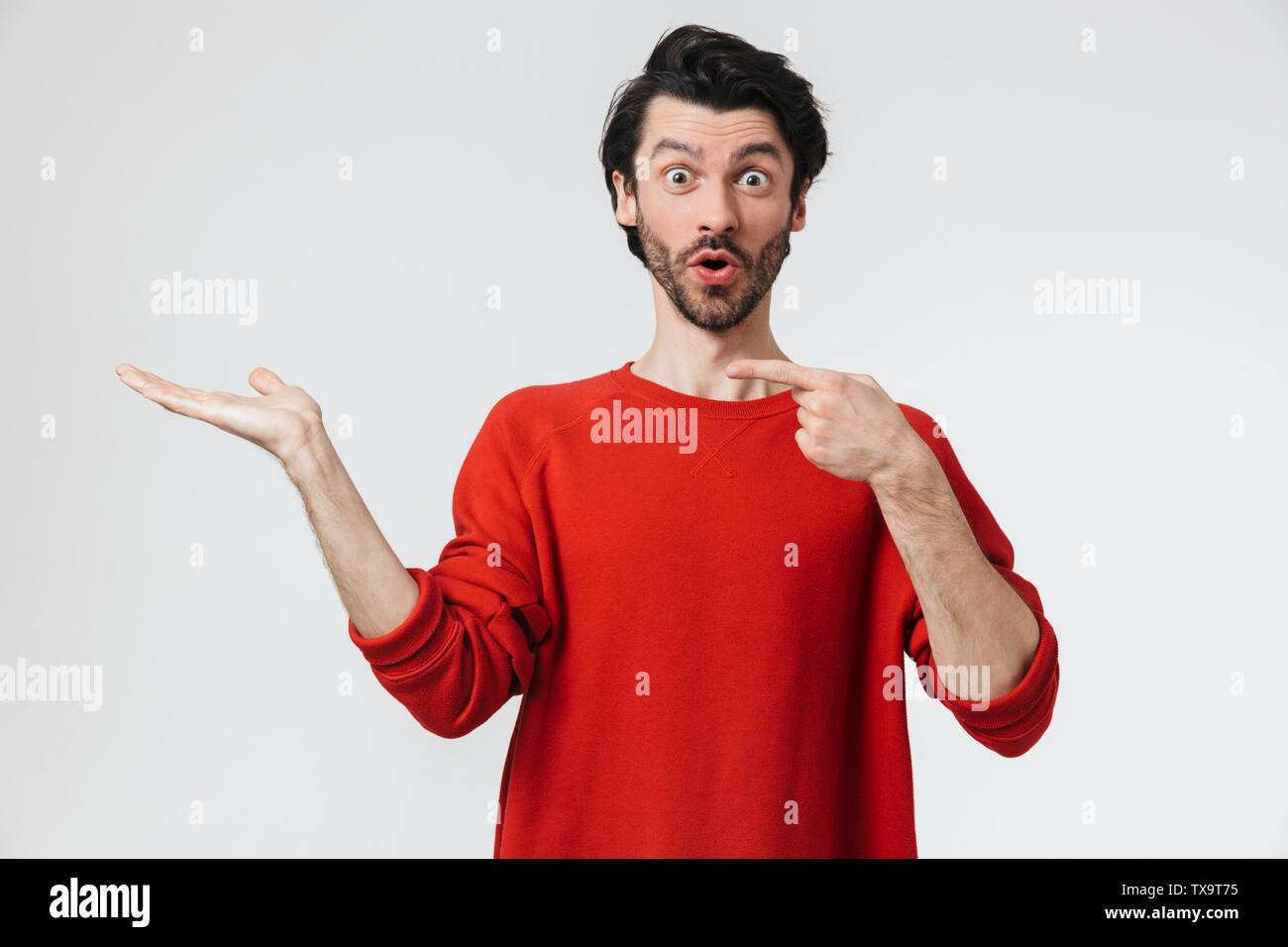 Picture of a handsome young shocked man posing isolated over white wall ...