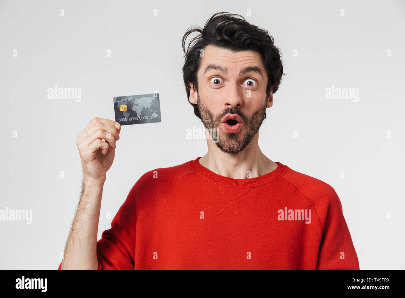 Image of a handsome young shocked man posing isolated over white wall ...