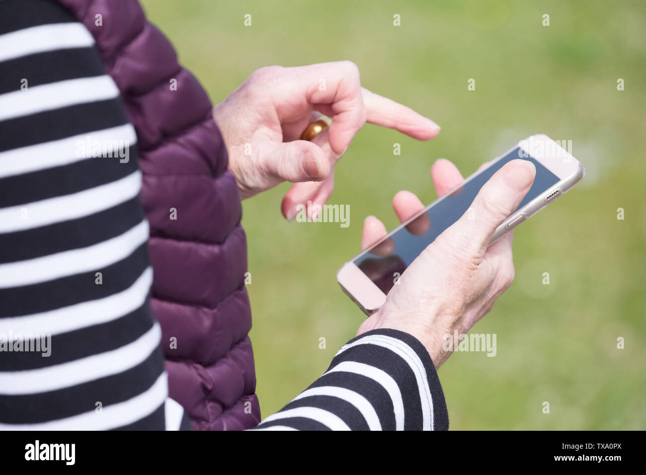 Senior elderly woman using touch screen mobile smart cell phone showing ...