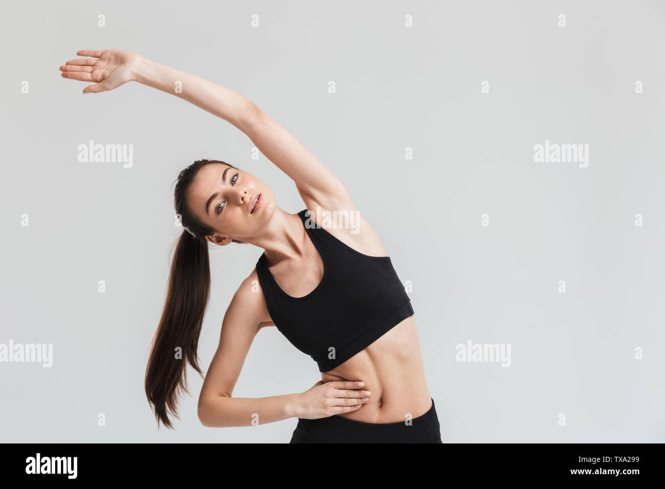 Image of a beautiful young sport fitness woman make exercises isolated ...