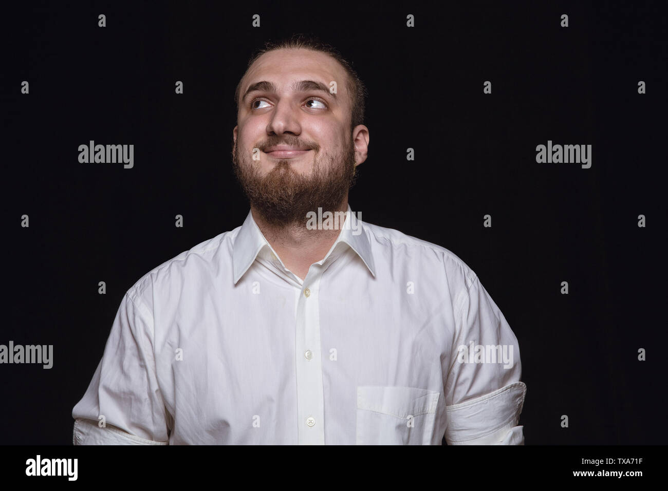 Close up portrait of young man isolated on black studio background ...