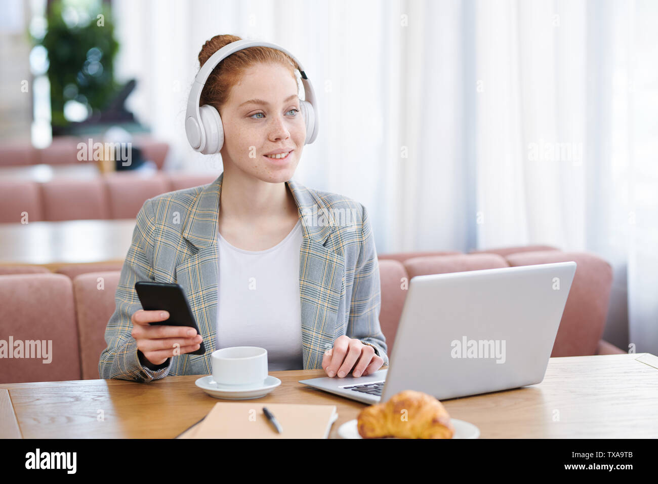 Positive technology-addicted teen girl in wireless headphones Stock ...