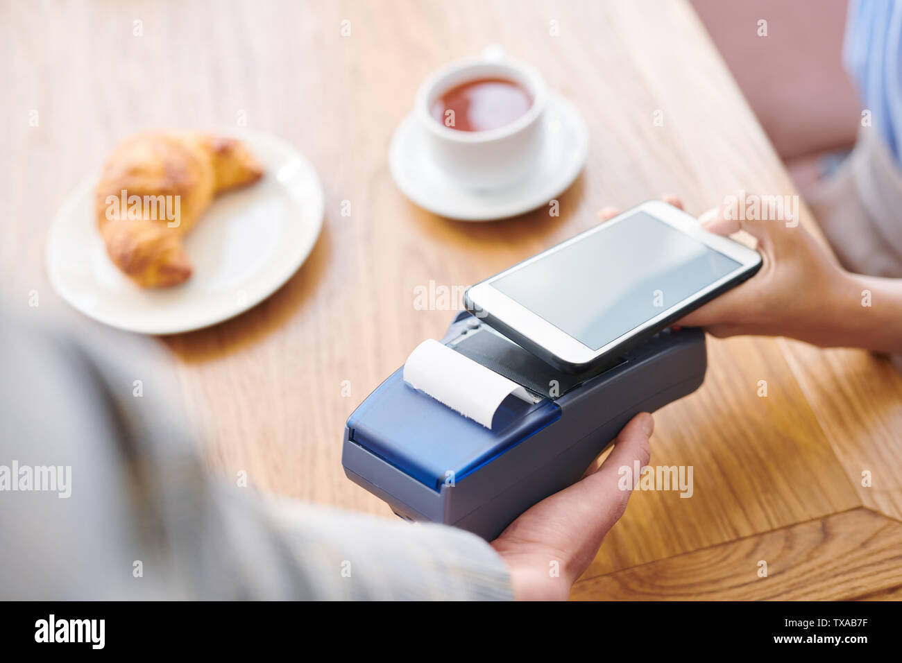 Paying through mobile payment system Stock Photo - Alamy