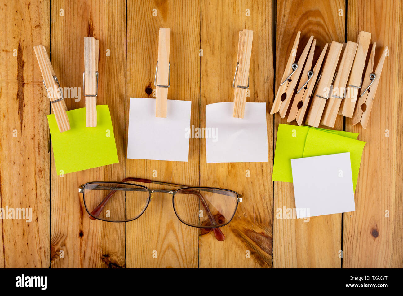 Colorful sticky notes hung on wooden clips. Sticky notes for saving ...