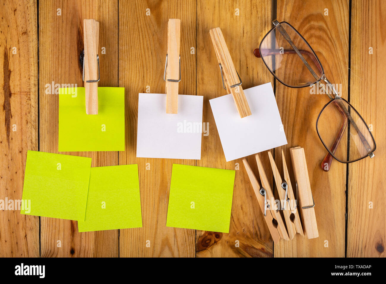 Colorful sticky notes hung on wooden clips. Sticky notes for saving ...