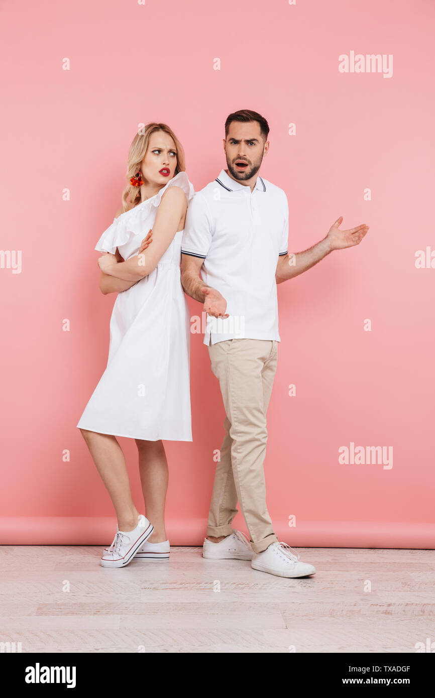 Full length of an angry attractive young couple standing together ...