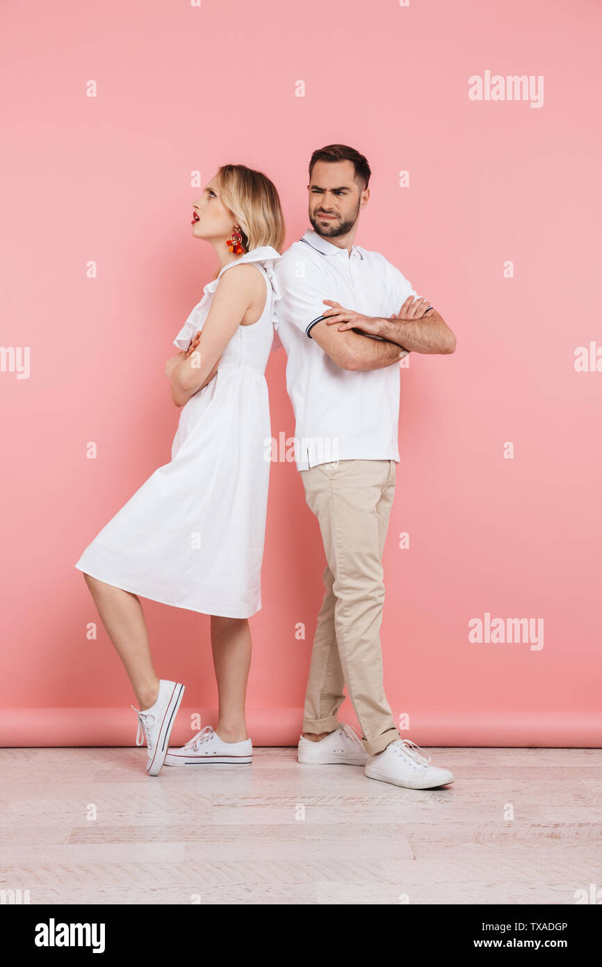 Full length of an angry attractive young couple standing together ...