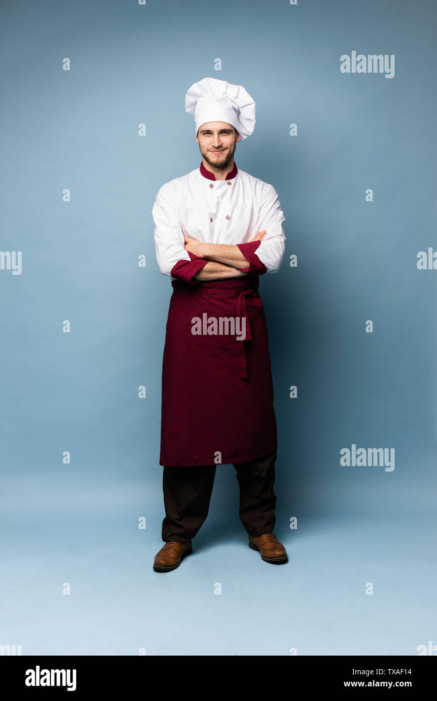Full length portrait of cheerful joyful chef cook with stubble in beret ...