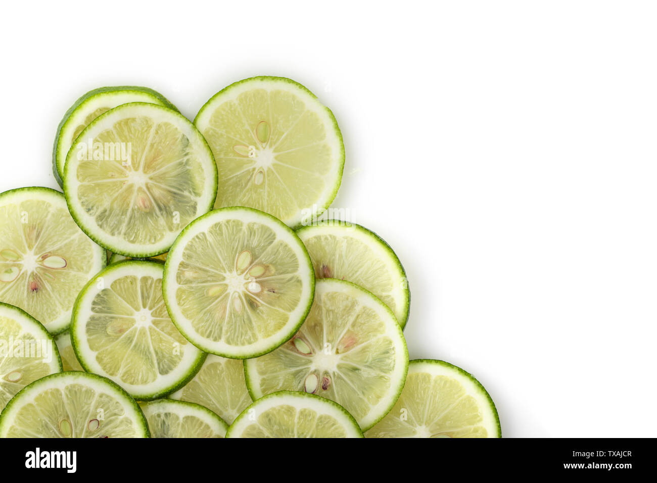 Green lemon slices on white background Stock Photo - Alamy