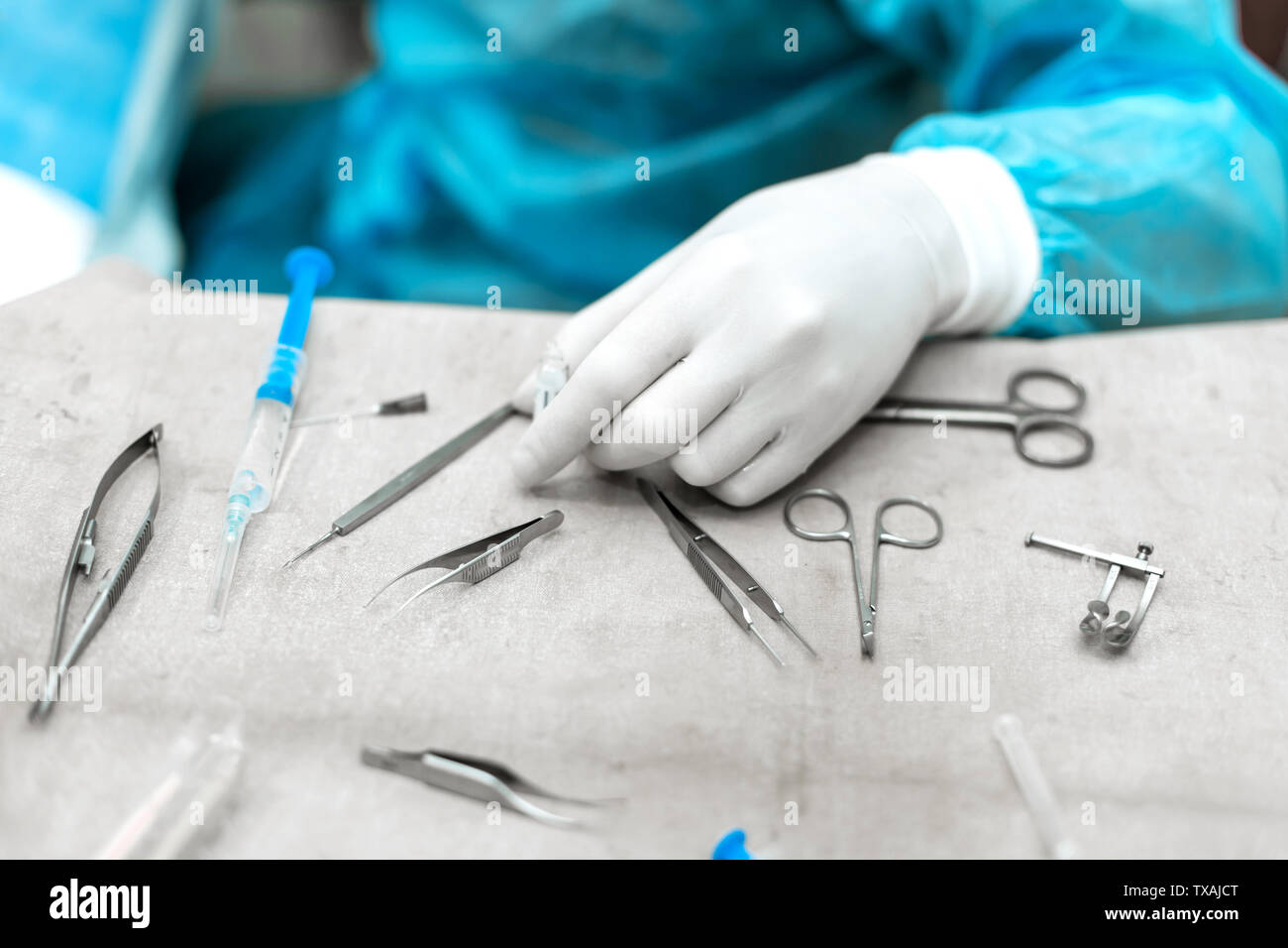surgeons hand taking scissors, forceps and surgical instruments on ...