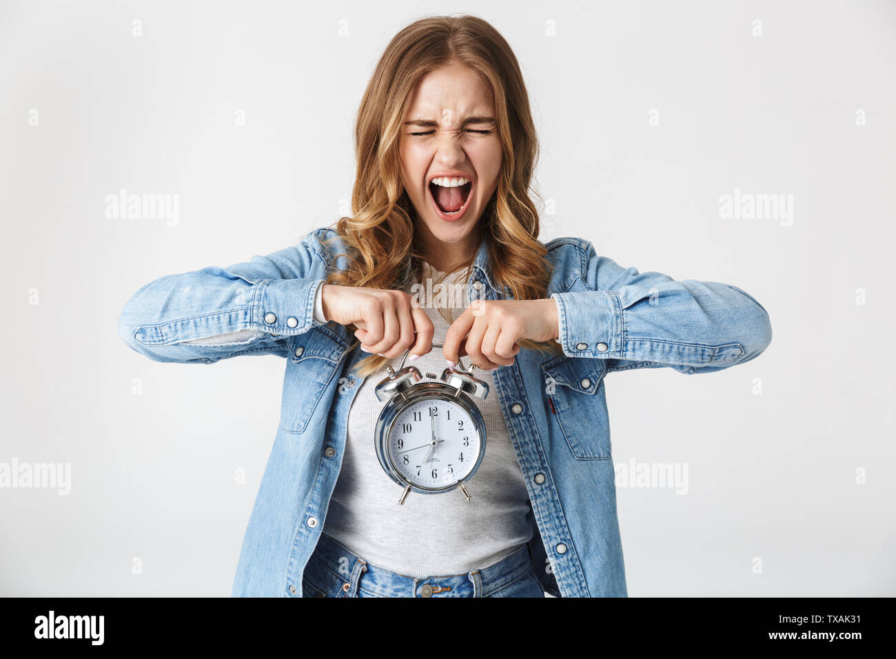 Attractive screaming young girl standing isolated over white background ...