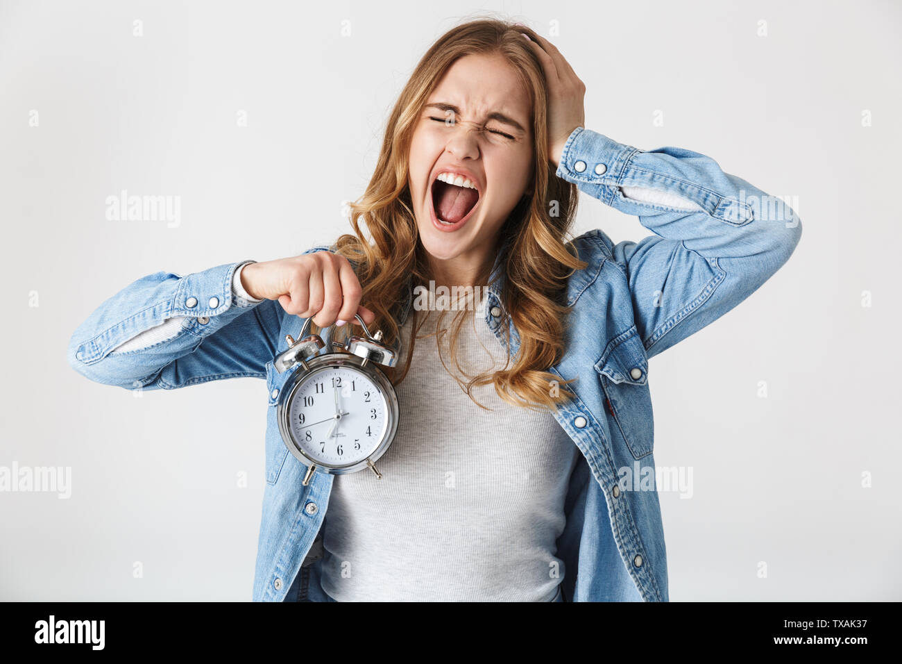Attractive screaming young girl standing isolated over white background ...