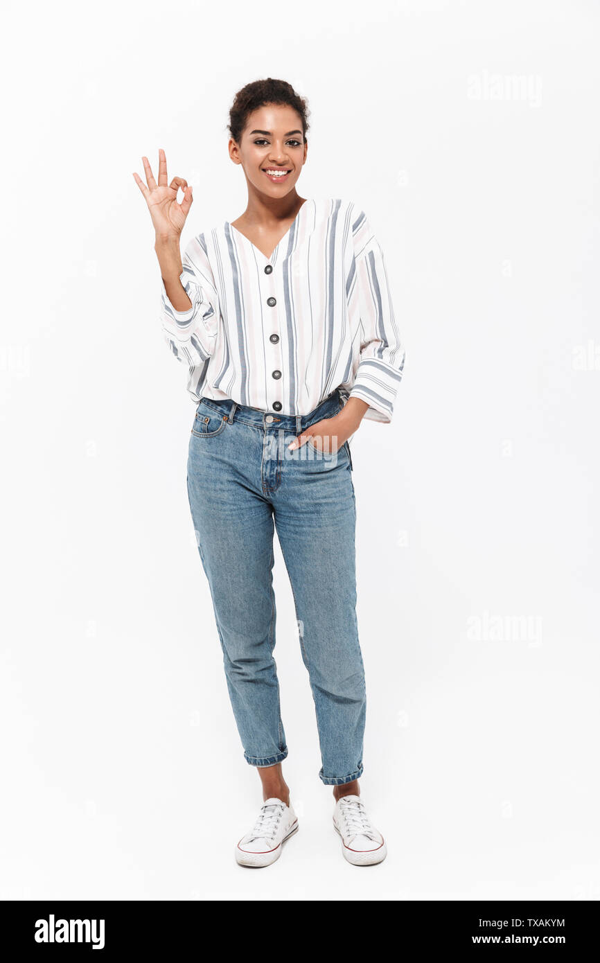 Full length portrait of an attractive young african woman standing ...