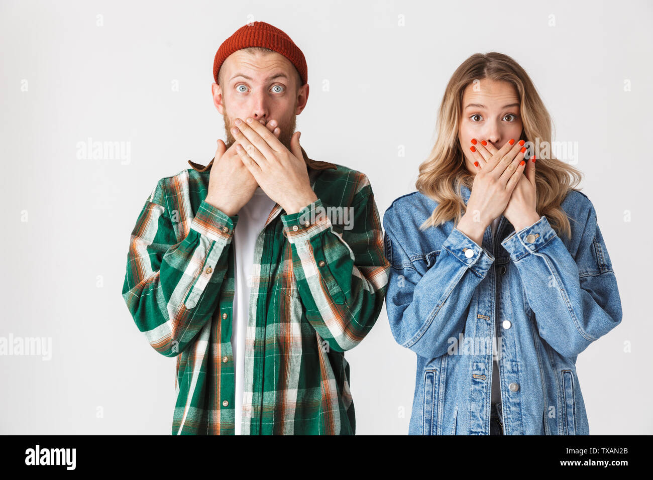 Image of a scared shocked emotional young loving couple posing isolated ...