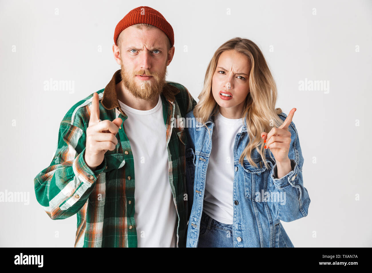 Photo of angry serious young loving couple posing isolated over white ...