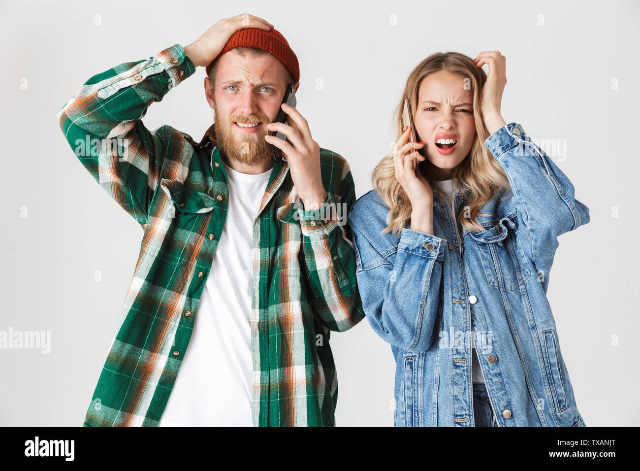 Image of shocked confused emotional young loving couple posing isolated ...