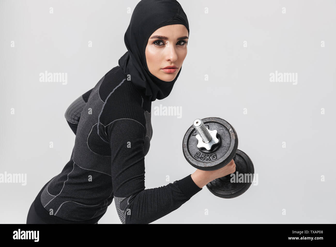Image of young woman fitness muslim posing isolated over white wall ...