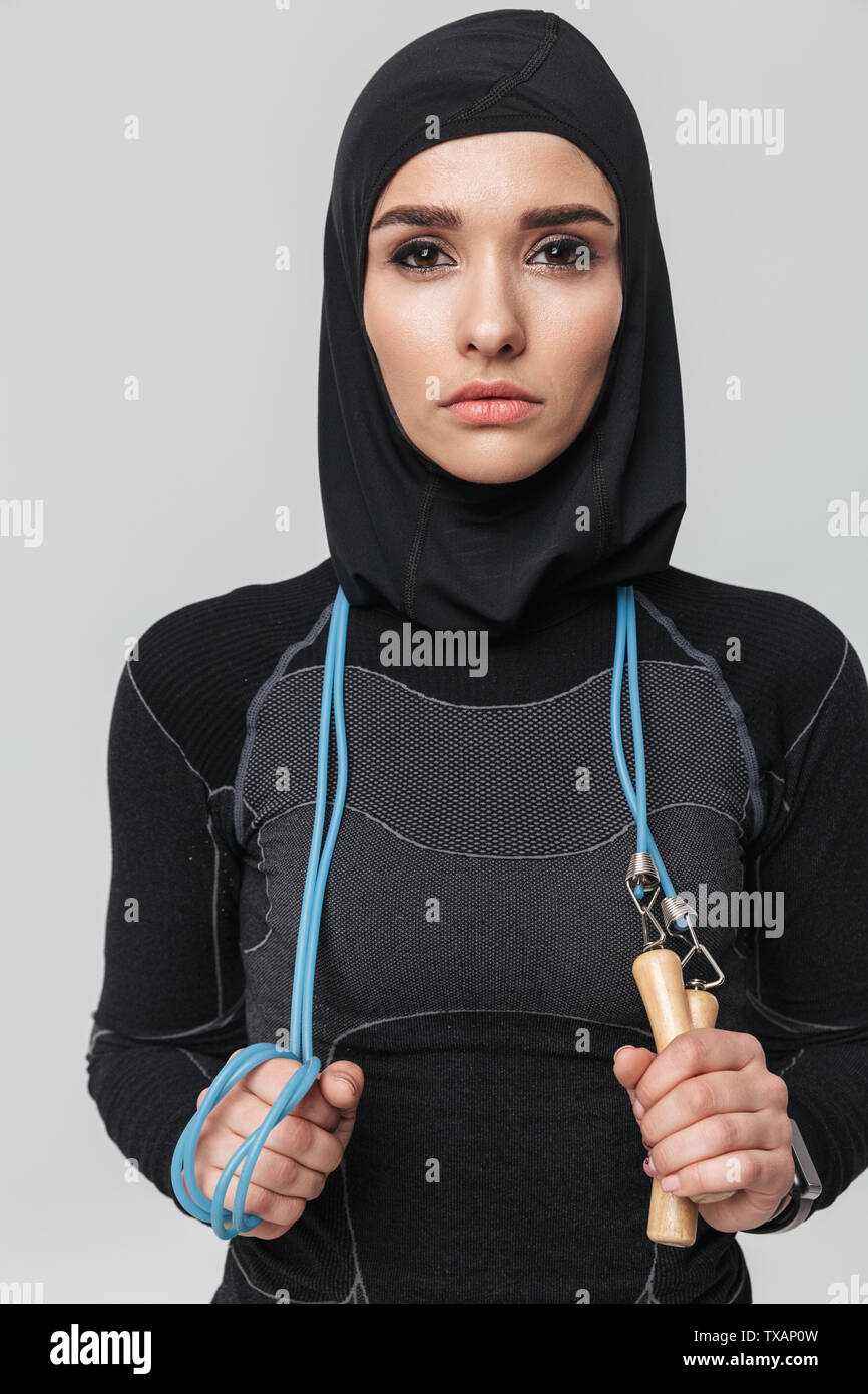 Image of young woman fitness muslim posing isolated over white wall ...