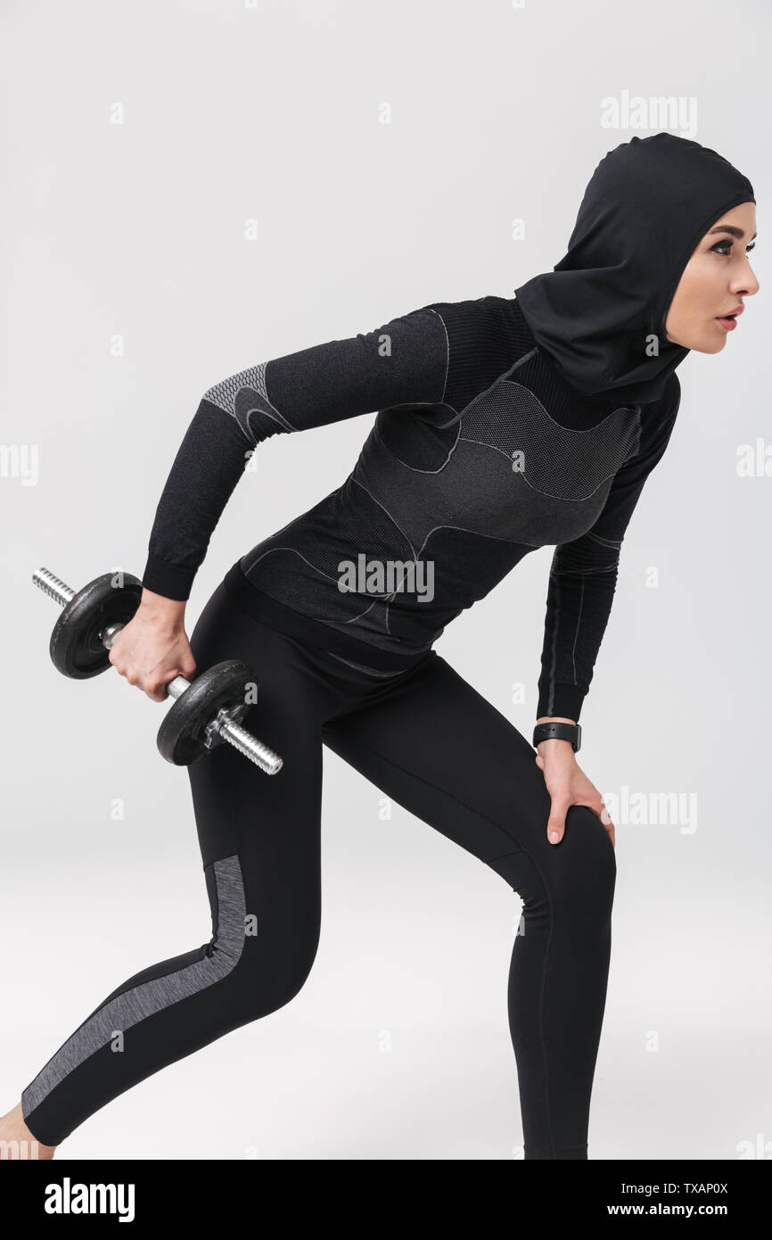 Image of young woman fitness muslim posing isolated over white wall ...
