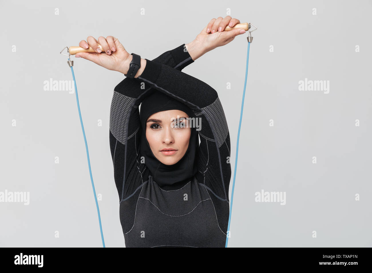 Image of young woman fitness muslim posing isolated over white wall ...