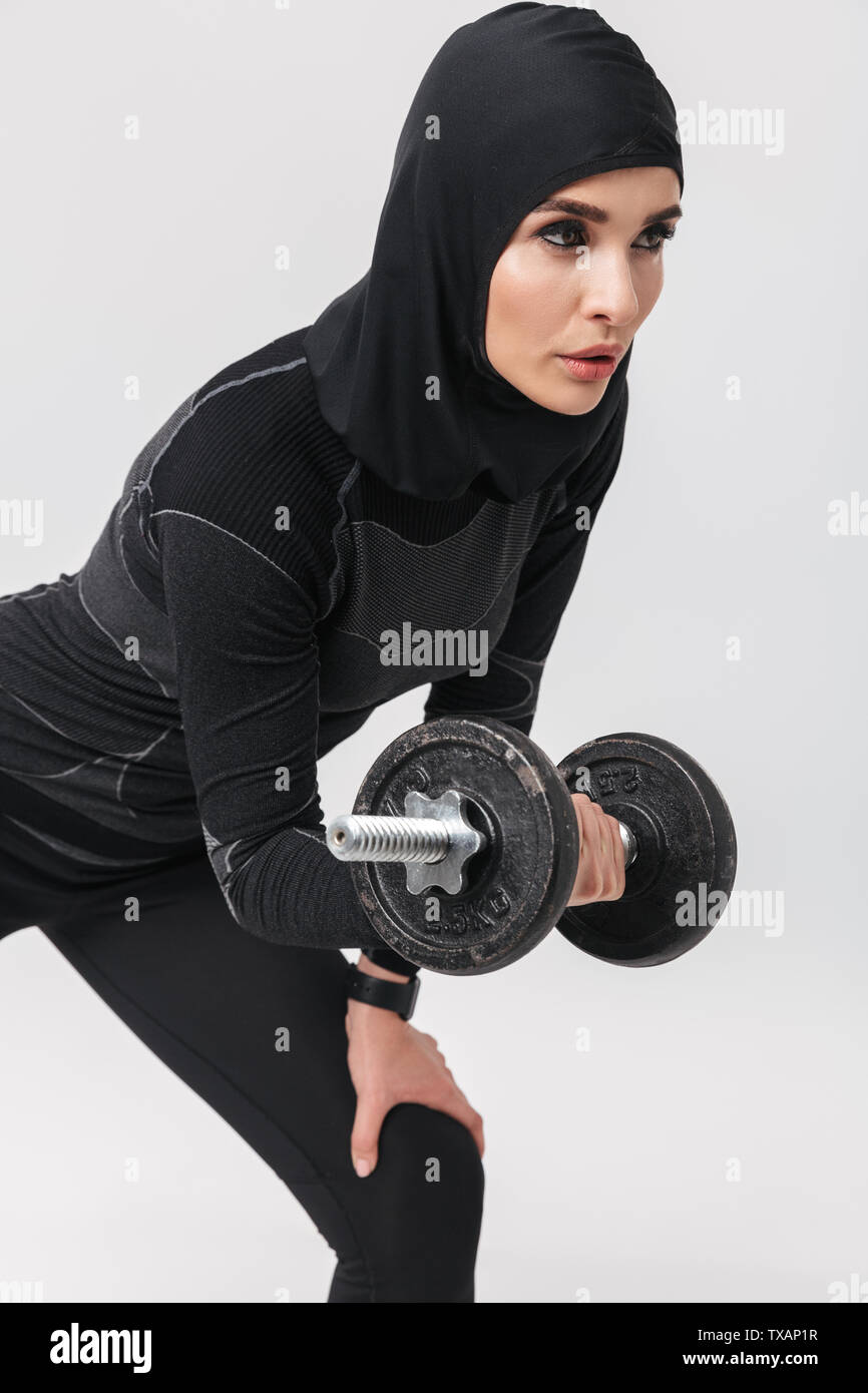 Image of young woman fitness muslim posing isolated over white wall ...