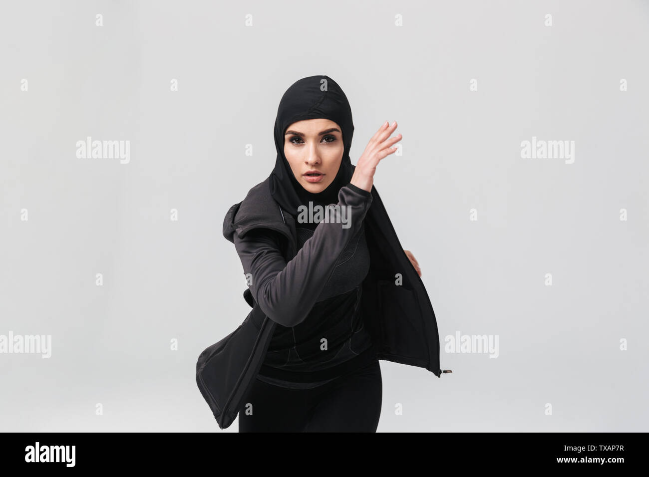 Attractive confident young muslim woman wearing sport hijab running ...