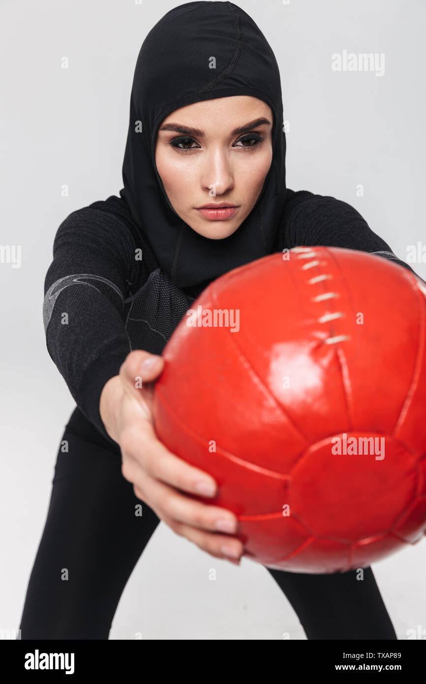 Image of young woman fitness muslim make exercises with ball isolated ...