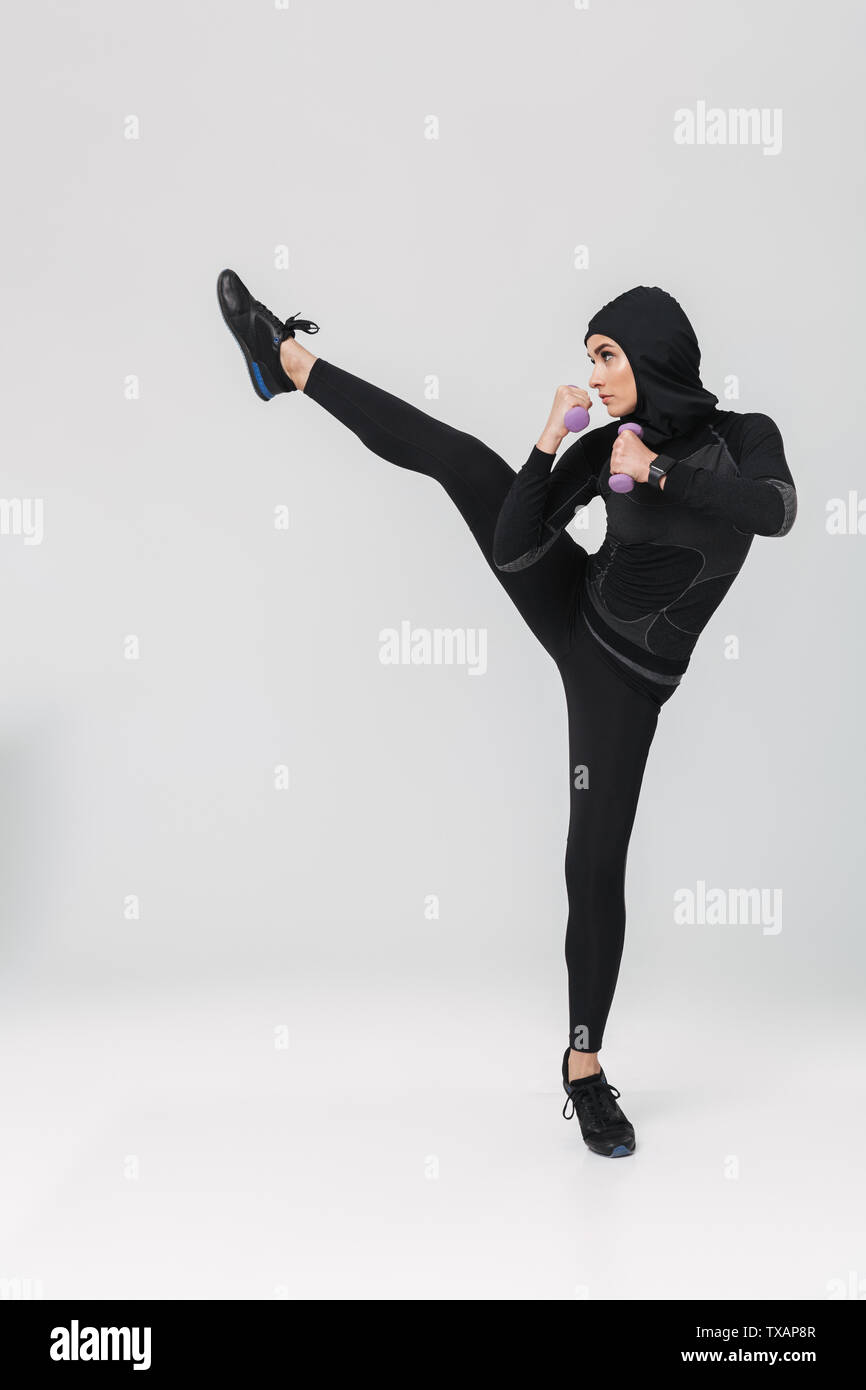 Image of young woman fitness muslim fighter boxer posing isolated over ...