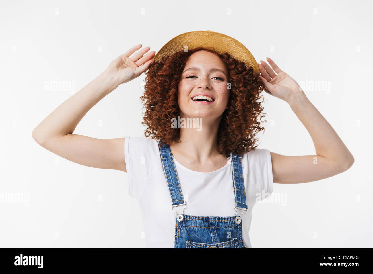 Portrait of charming redhead curly woman 20s wearing summer straw hat ...