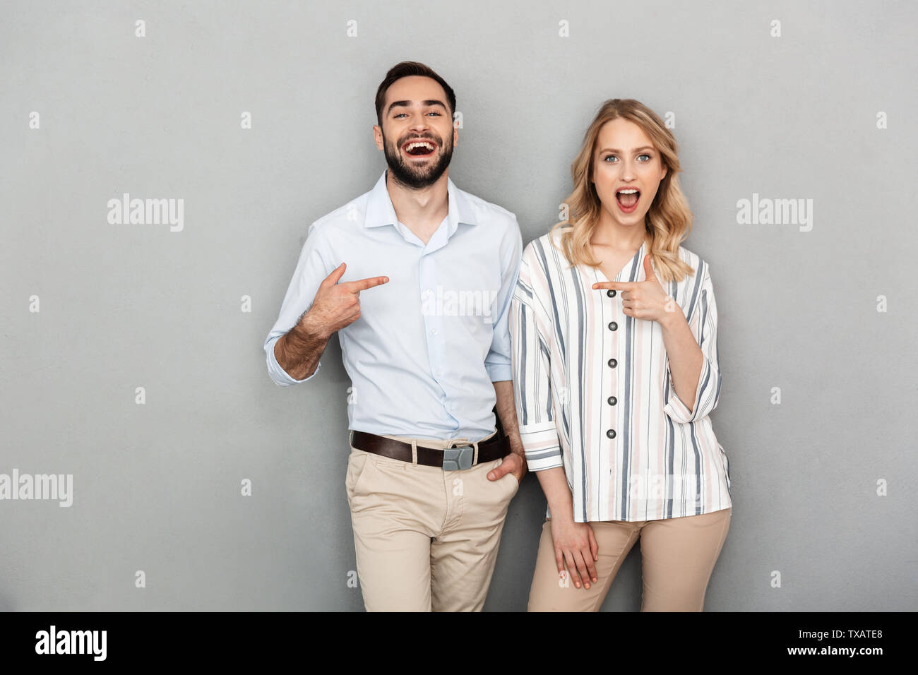 Two friends smiling pointing other hi-res stock photography and images ...
