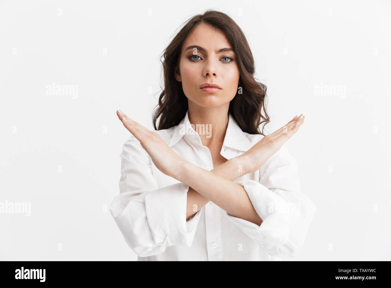 Beautiful angry young woman with long curly brunette hair wearing white ...
