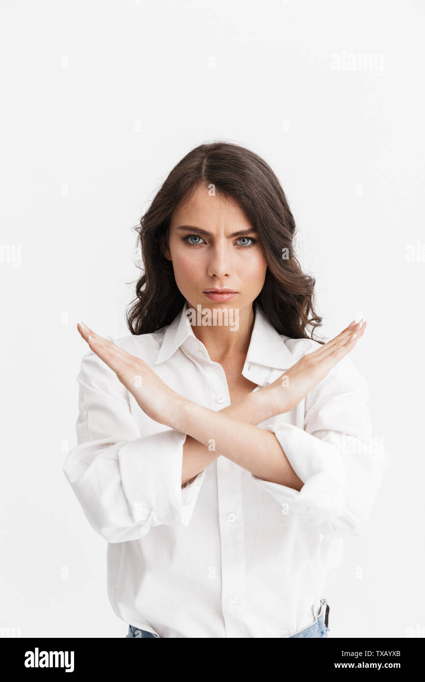 Beautiful angry young woman with long curly brunette hair wearing white ...