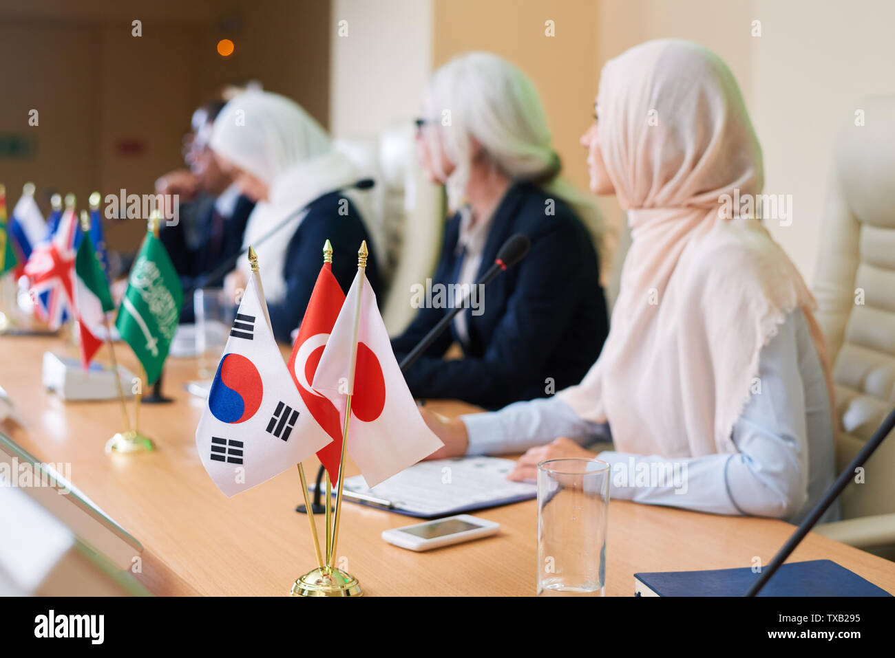 Bunch of flags of several foreign countries on table Stock Photo - Alamy