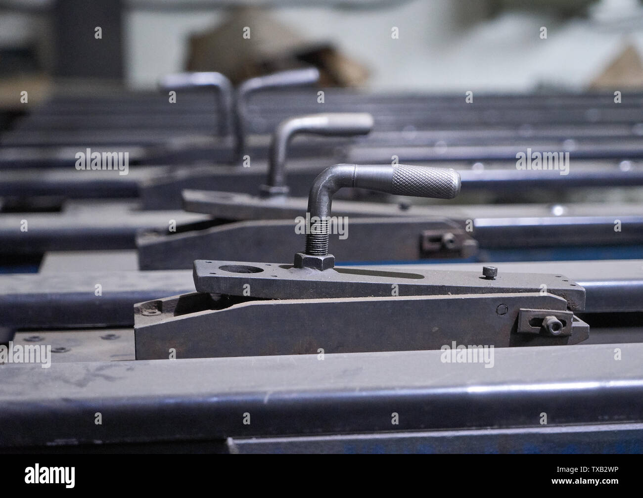 Close-up of mechanical handles in the production workshop Stock Photo ...