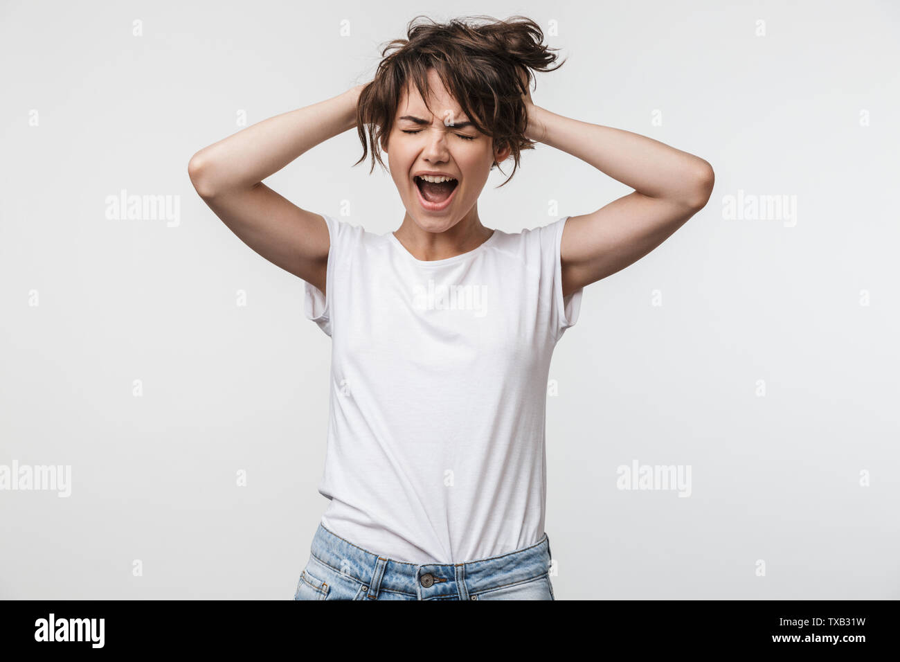 Image of shocked woman with short hair in basic t-shirt screaming and ...