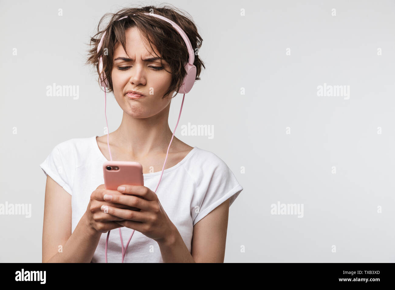 Image of a beautiful young pretty confused woman posing isolated over ...