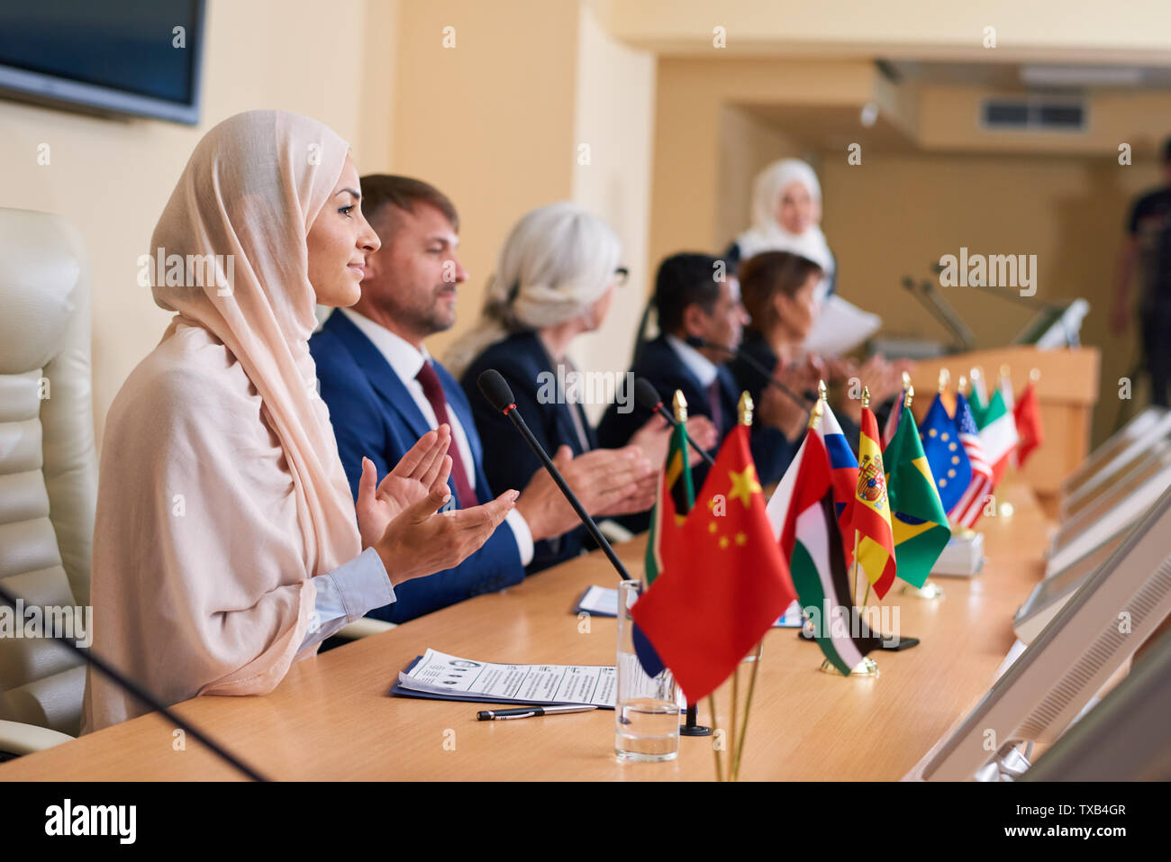 Colleagues clapping female colleague hi-res stock photography and ...