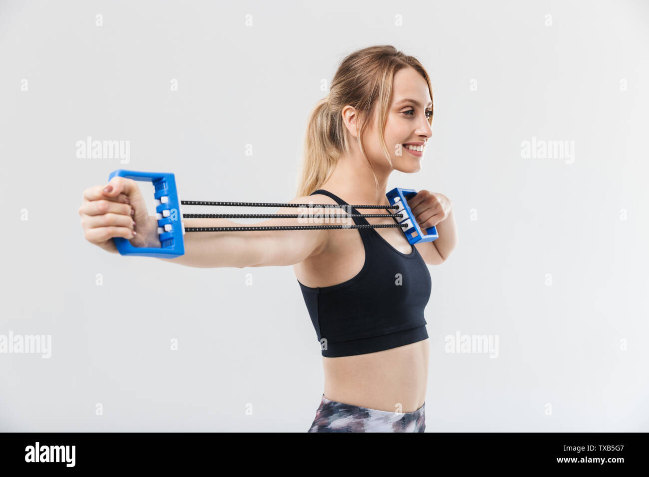 Image of strong blond woman 20s dressed in sportswear stretching ...