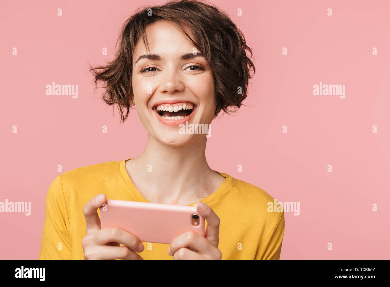 Image of a happy young beautiful woman posing isolated over pink wall ...