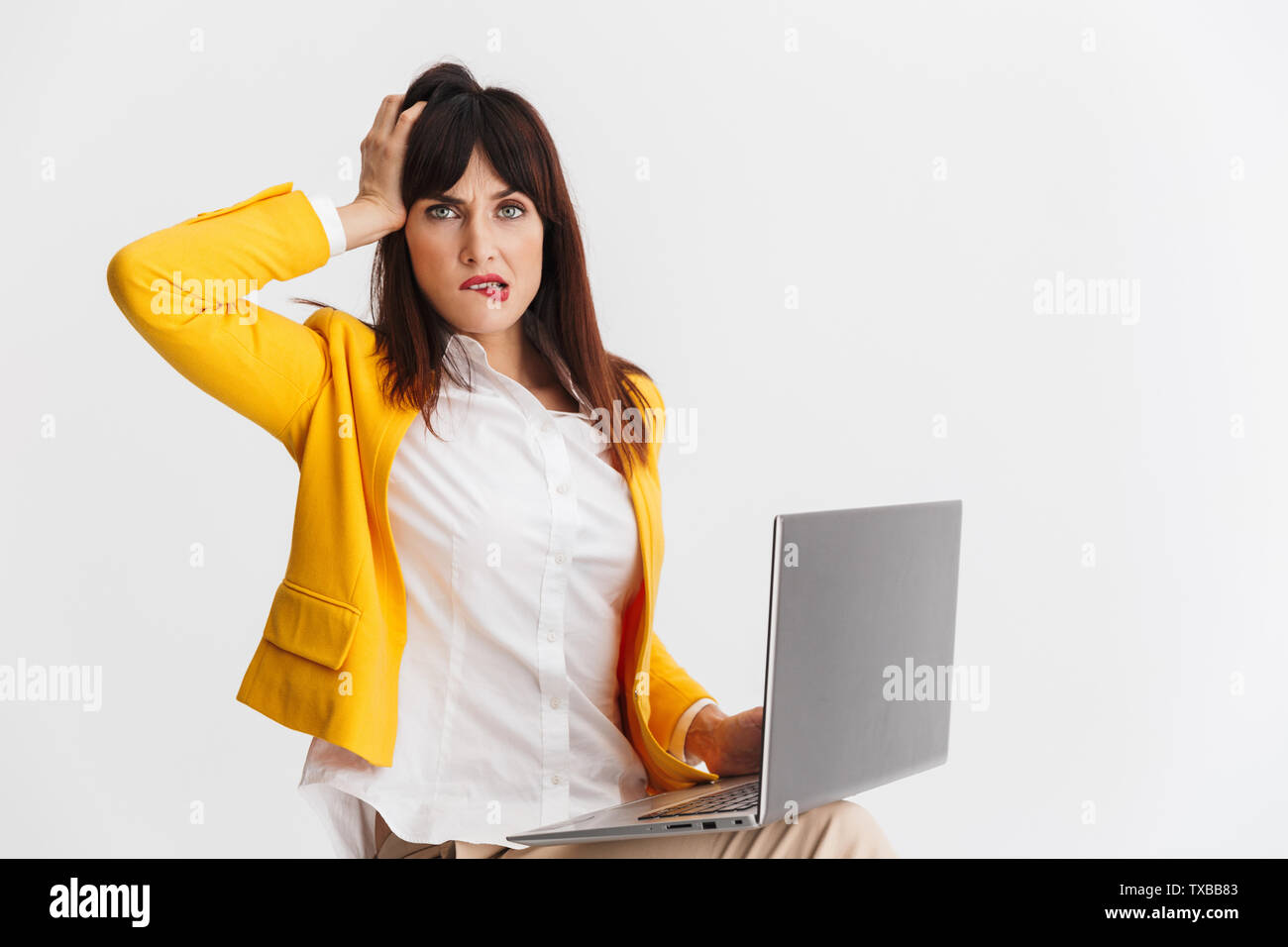 Image of a beautiful young confused business woman posing isolated over ...
